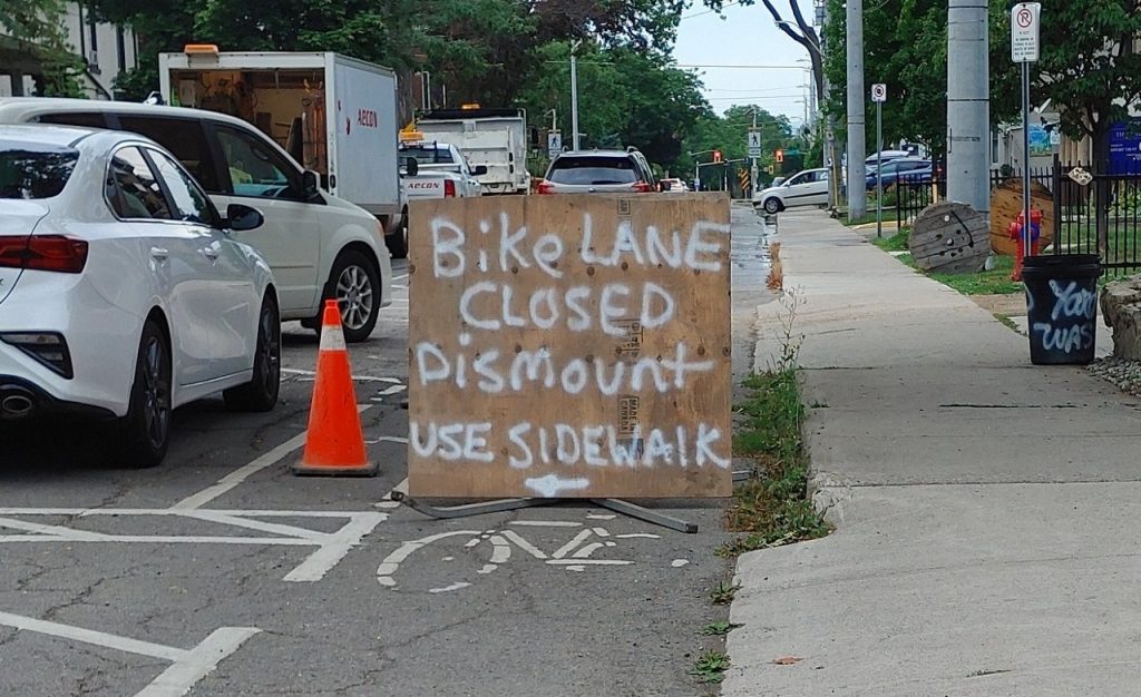 'Dismount'; Hamilton bike lane closure marked with crudely lettered ...